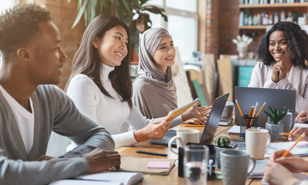 Work colleagues in meeting around a table
